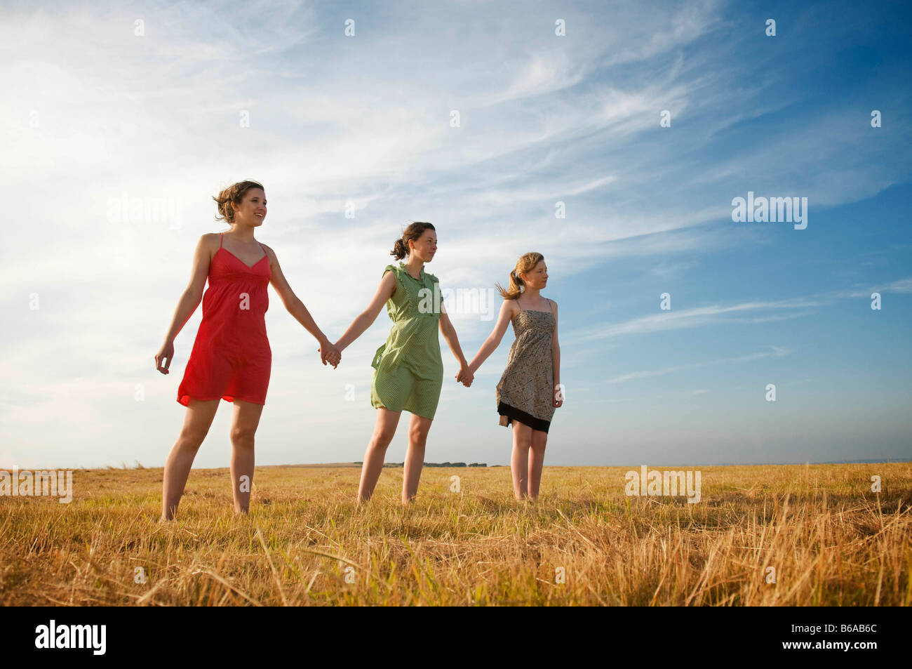 Three teenage girls hold hands Stock Photo - Alamy