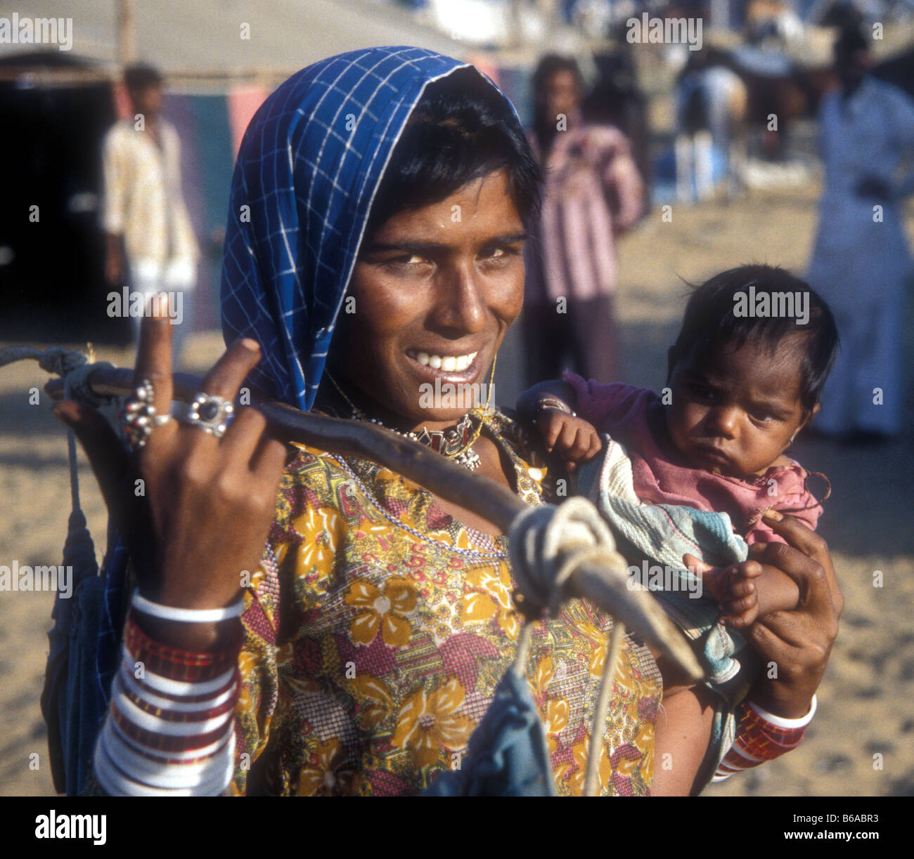 A woman with her baby at the Pushkar camel fair India Stock Photo - Alamy