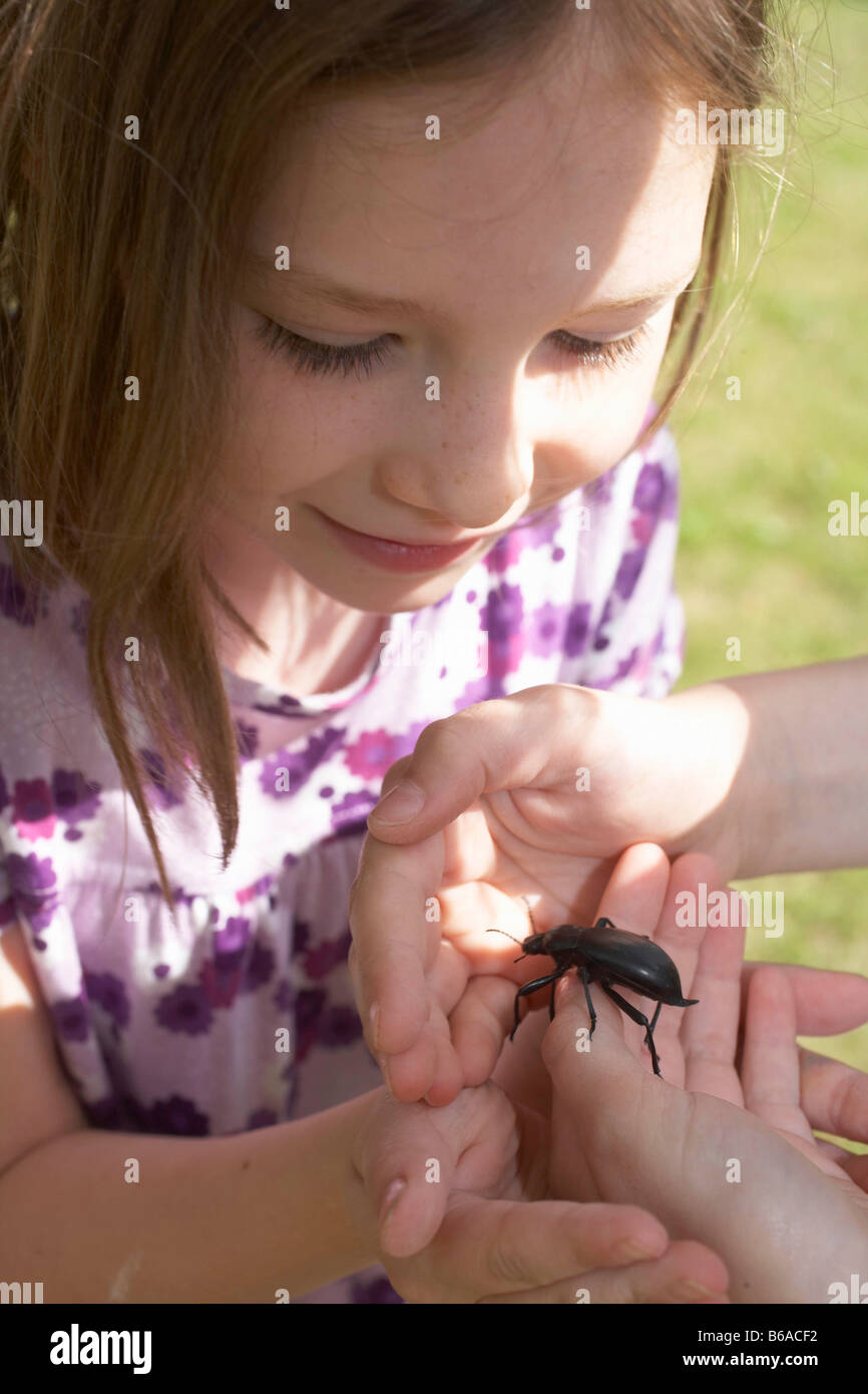 Young girl looking at an insect Stock Photo - Alamy