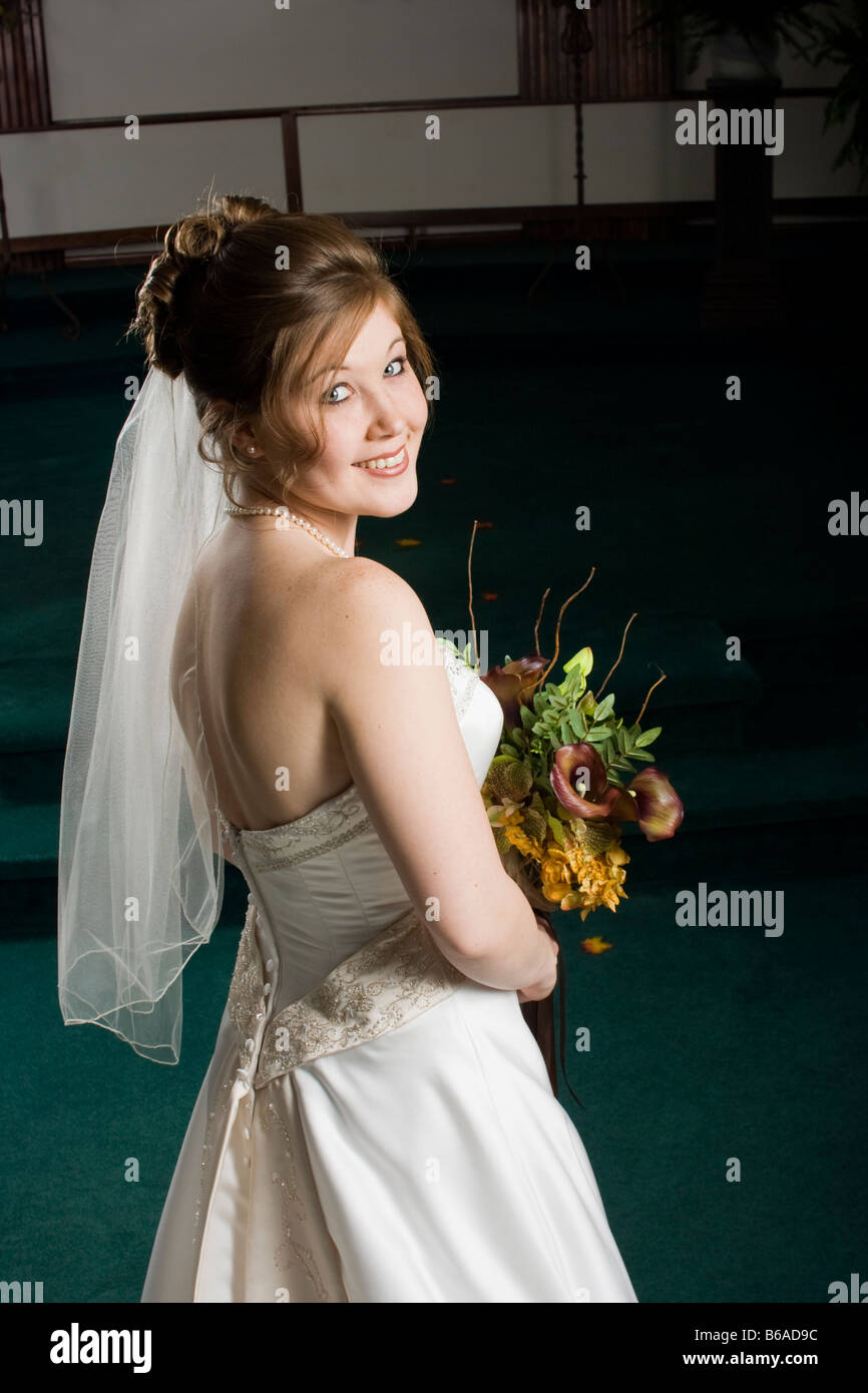 Bride looking over shoulder toward camera from behind Stock Photo - Alamy