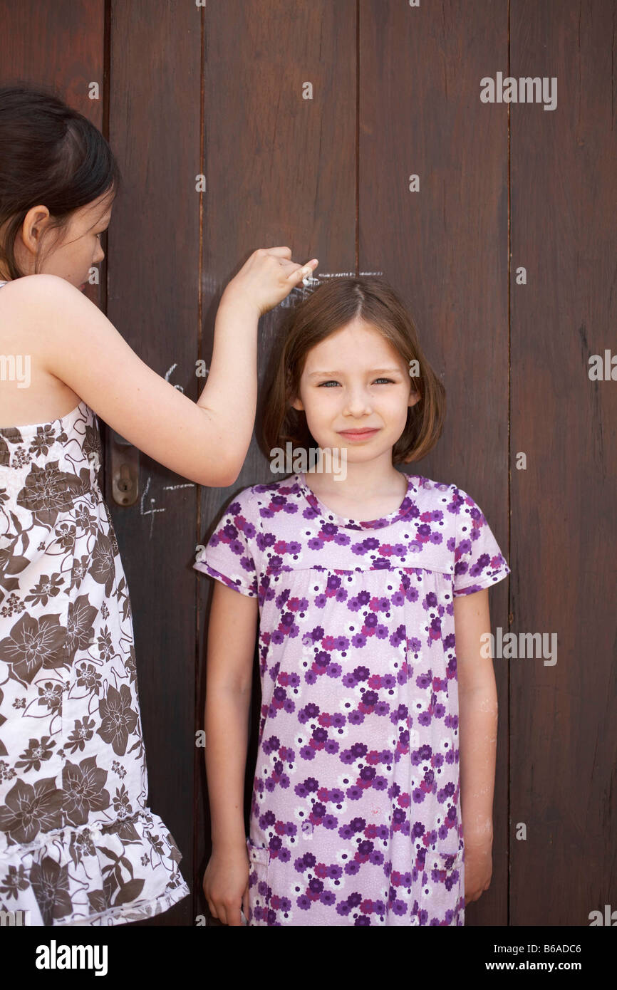 Young girls measuring themselves Stock Photo - Alamy