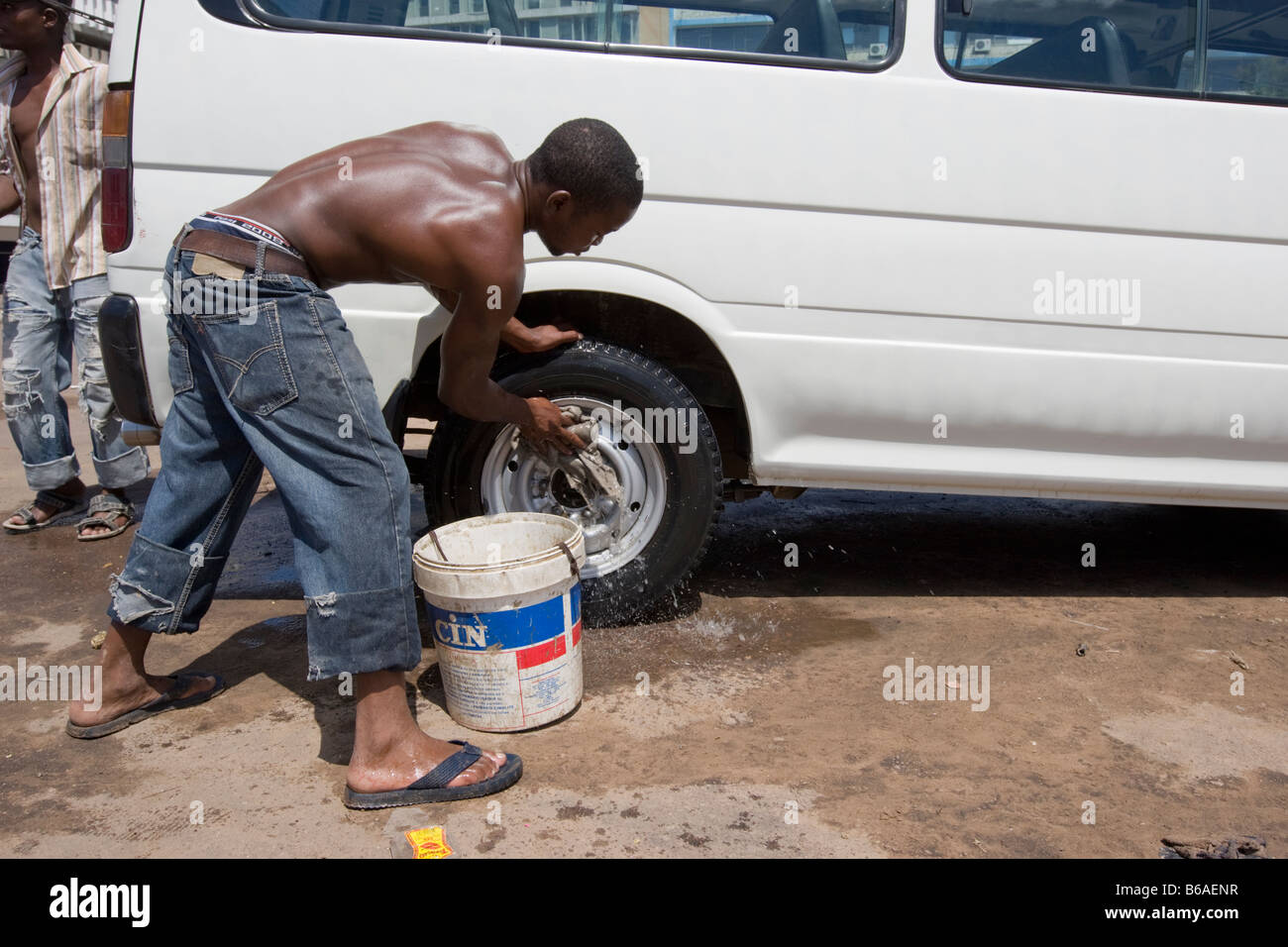 Africa Mozambique Maputo Young men work cleaning taxi vans in Praça dos ...