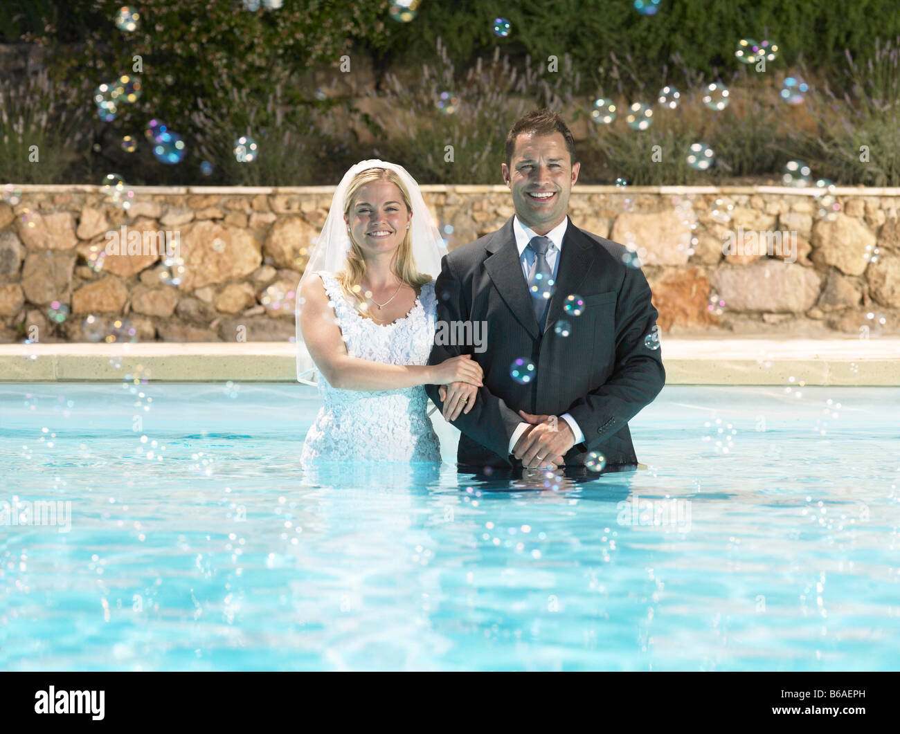 Bride and groom in pool Stock Photo - Alamy