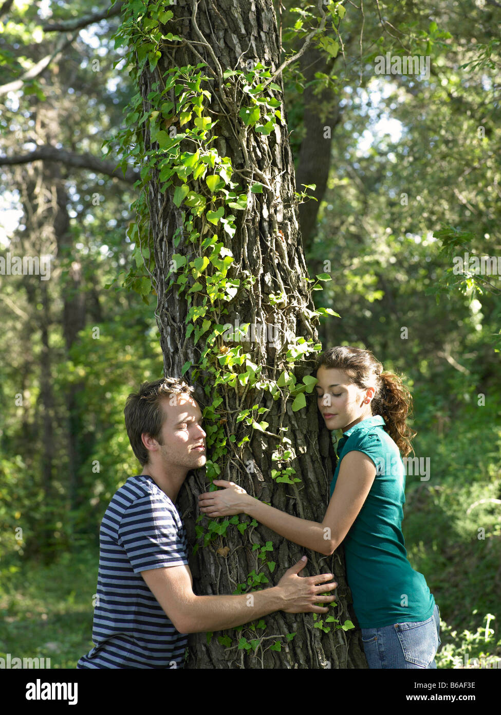 Couple hugging tree Stock Photo - Alamy