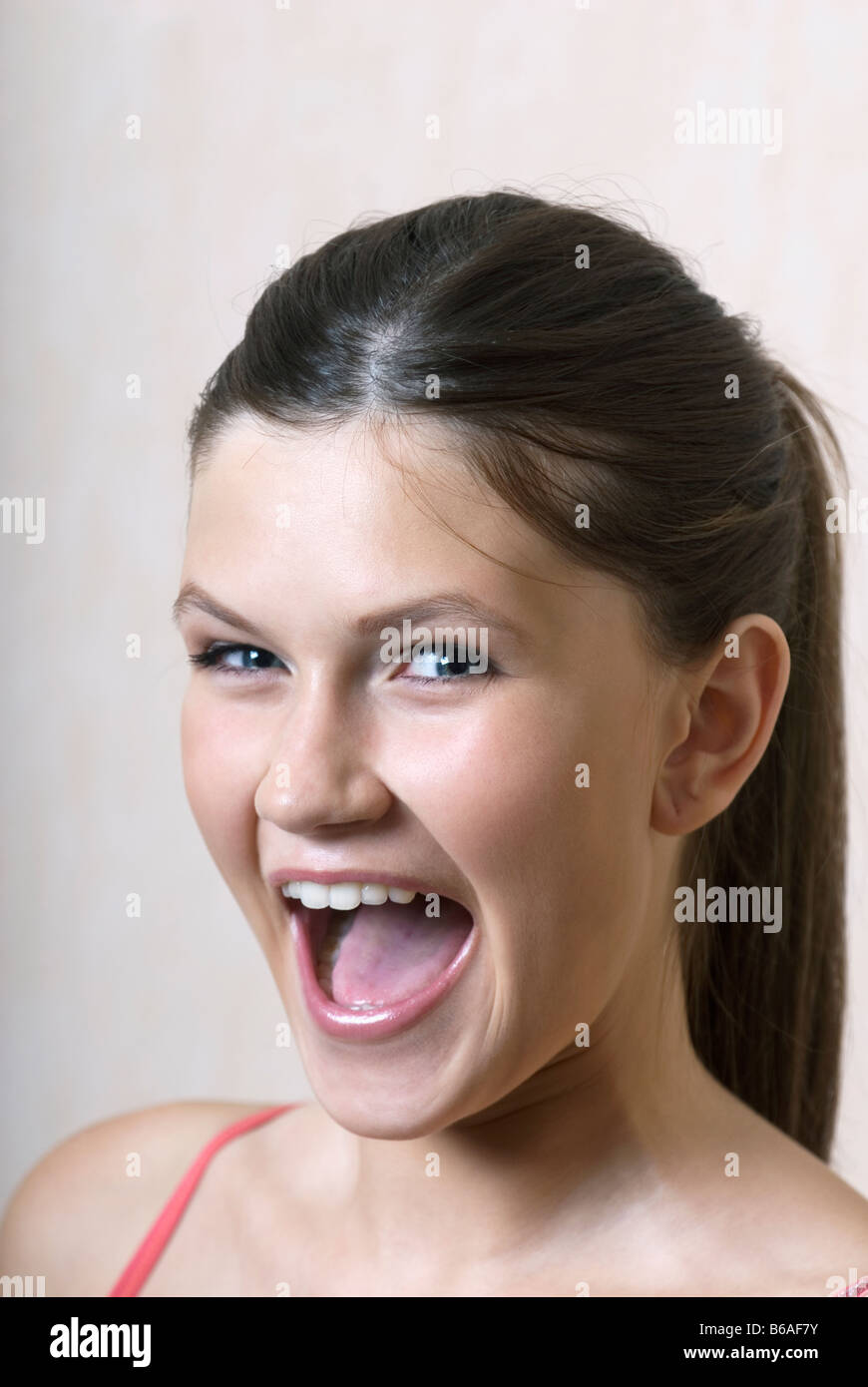 Studio portrait of young woman with open mouth Stock Photo - Alamy