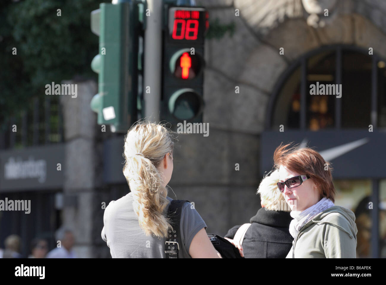 Two girls waits for green light Stock Photo - Alamy