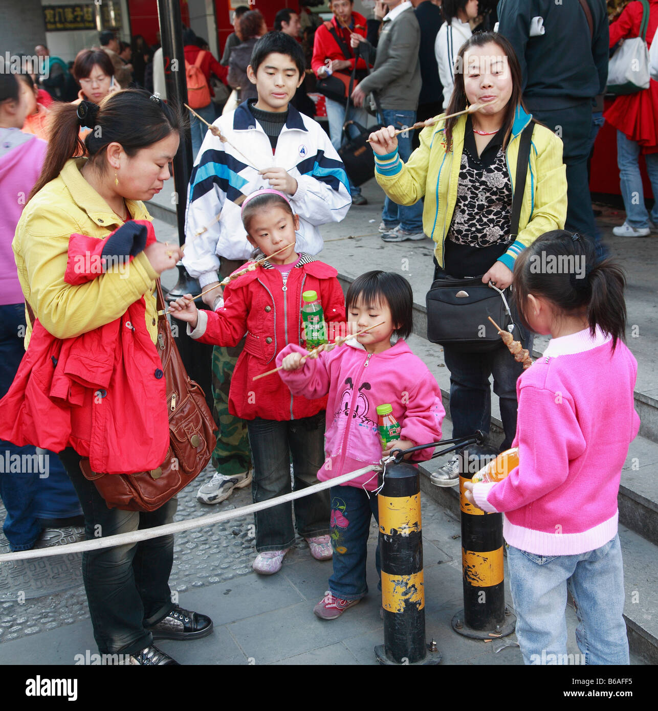 China Beijing Dazhalan traditional shopping street people eating snacks ...