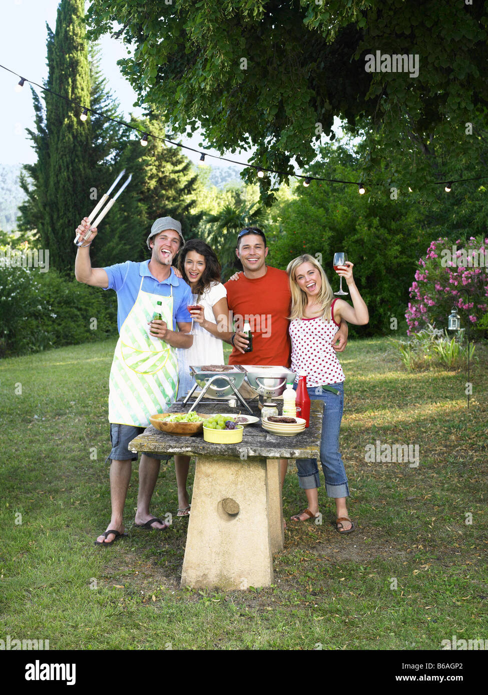 Friends celebrating at barbecue Stock Photo - Alamy
