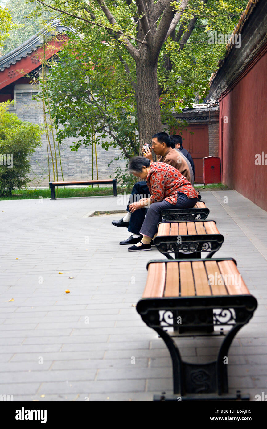 CHINA BEIJING Chinese tourists resting on benches in beautiful Jinghan ...