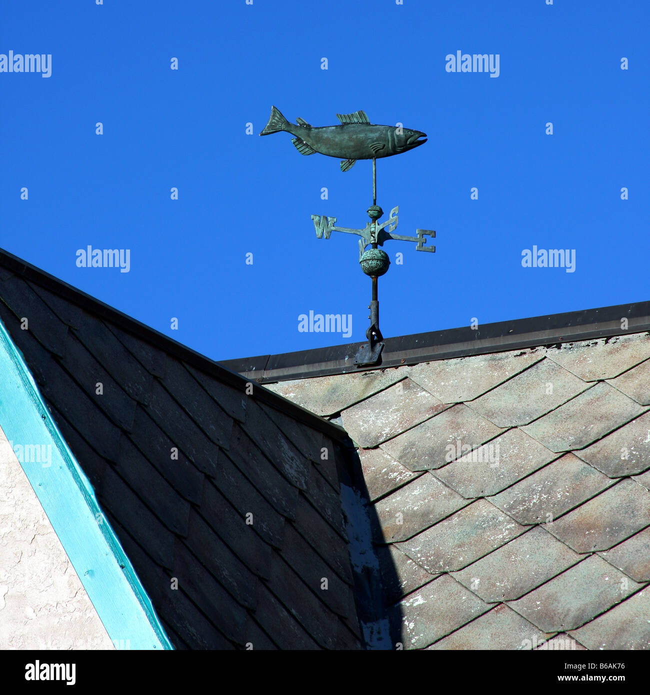 Fish Weather vane on peak of a roof, blue sky, patina on metal Stock ...