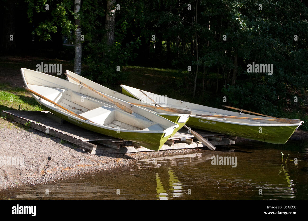 Beached green fiberglass rowboats / skiffs , Finland Stock Photo - Alamy