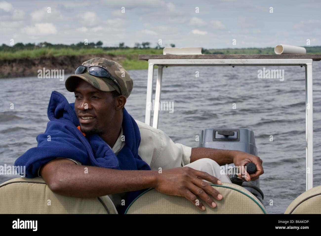 Africa Botswana Chobe National Park Safari guide pilots motor boat ...