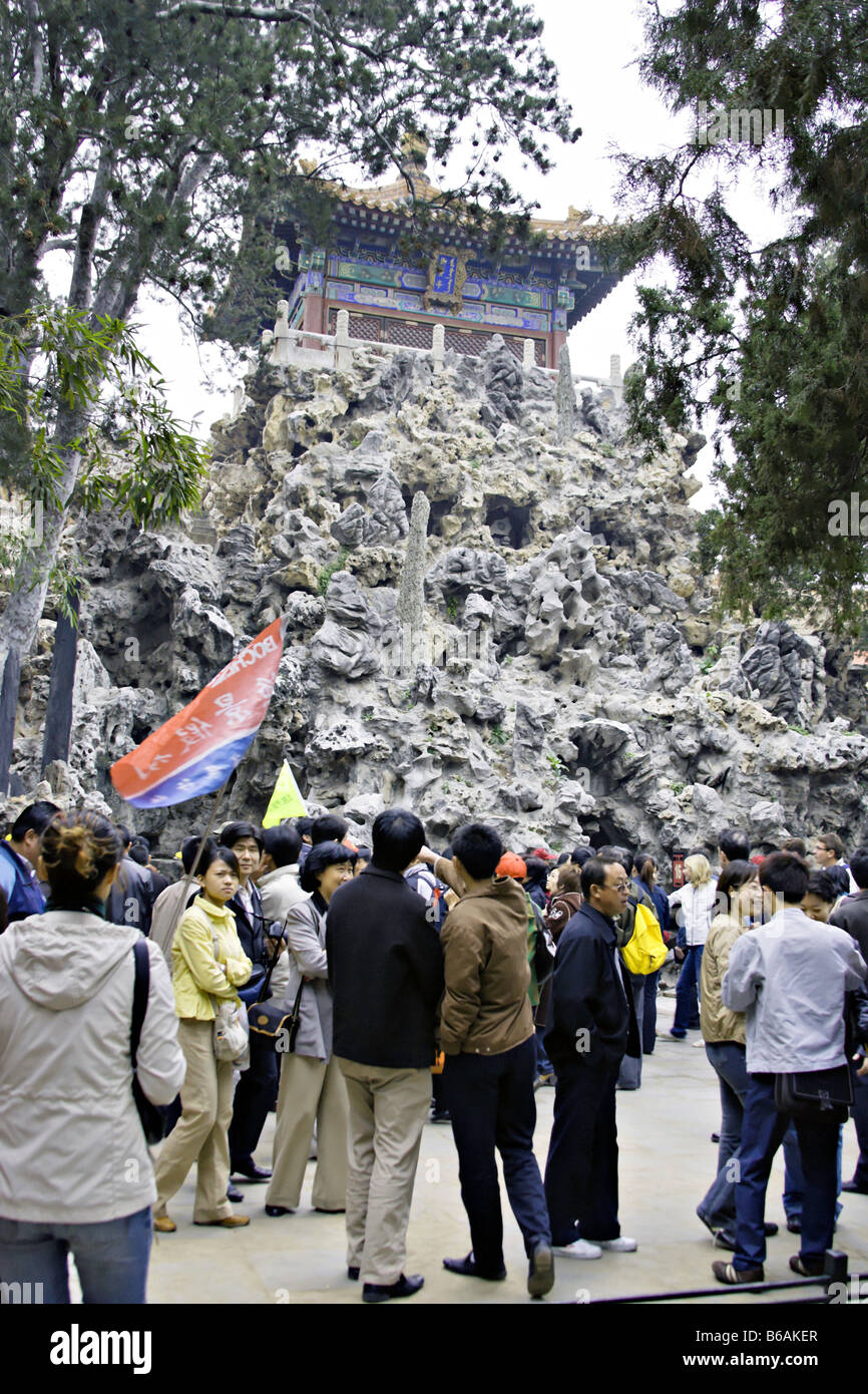 CHINA BEIJING Crowds of Chinese tour groups following guides with flags ...