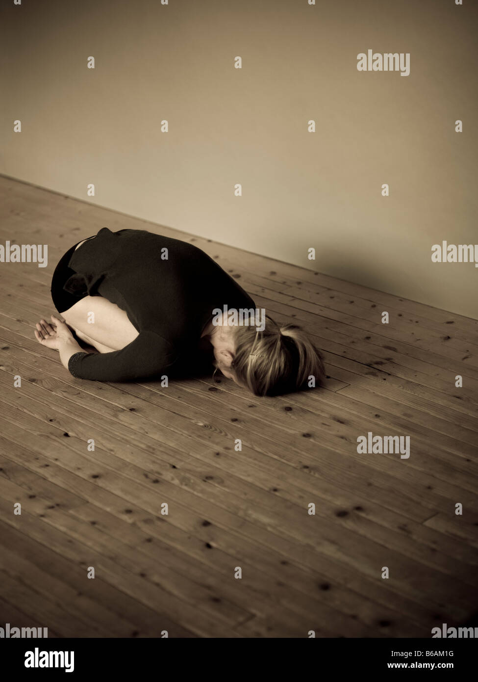 a woman holding her hands on the floor and resting in Yoga pose Stock ...