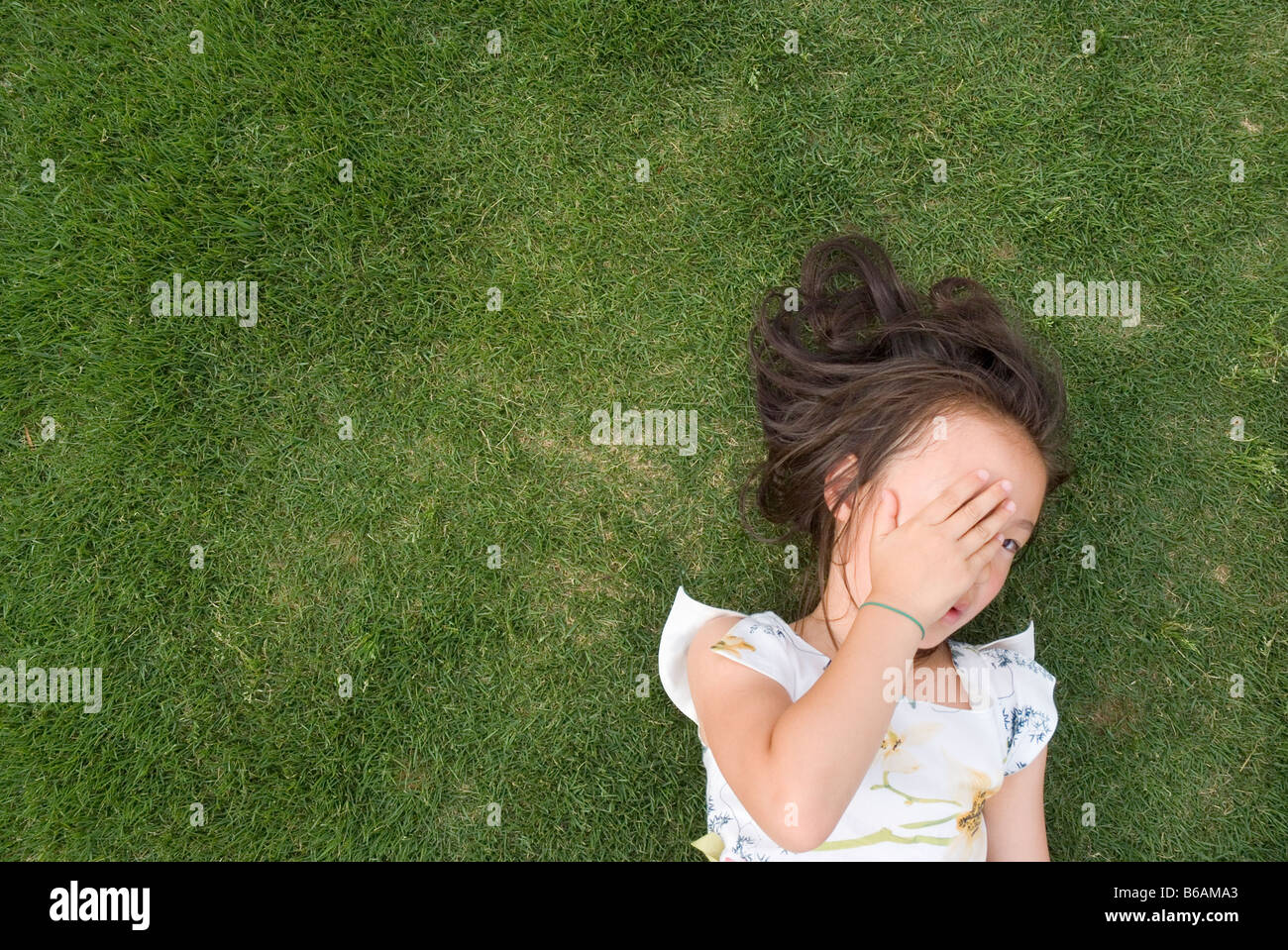Girl hiding face with hand Stock Photo - Alamy