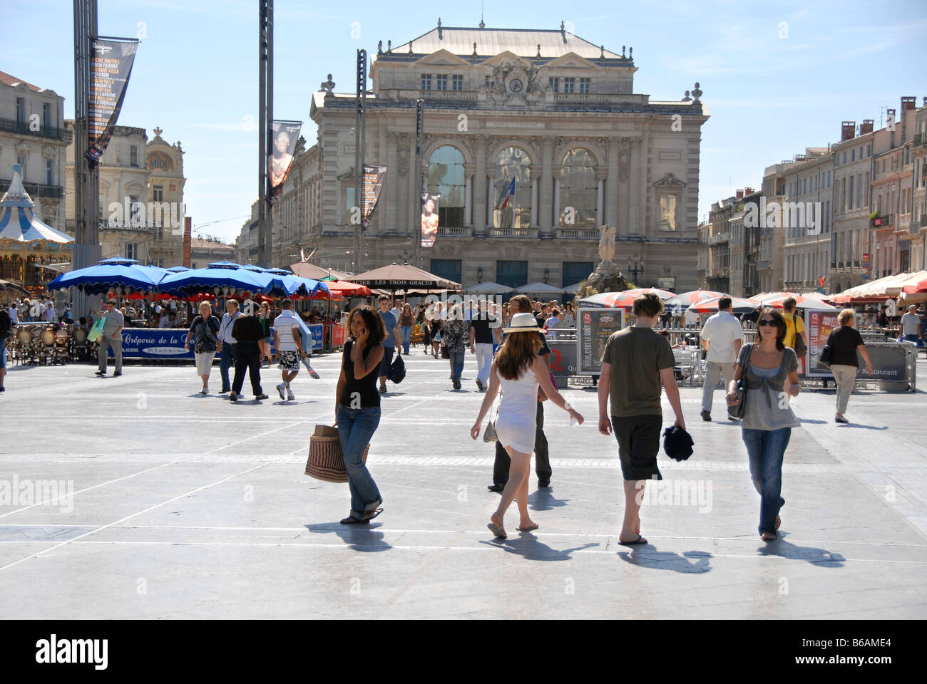 People on the historic main square "Place de la Comedie", Opera house ...