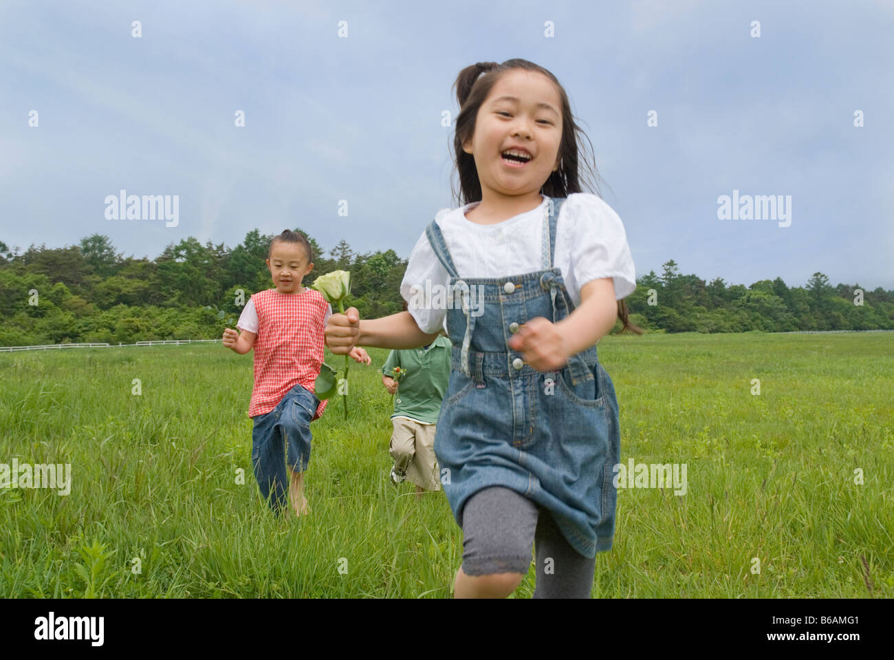 Children running on grass field Stock Photo - Alamy