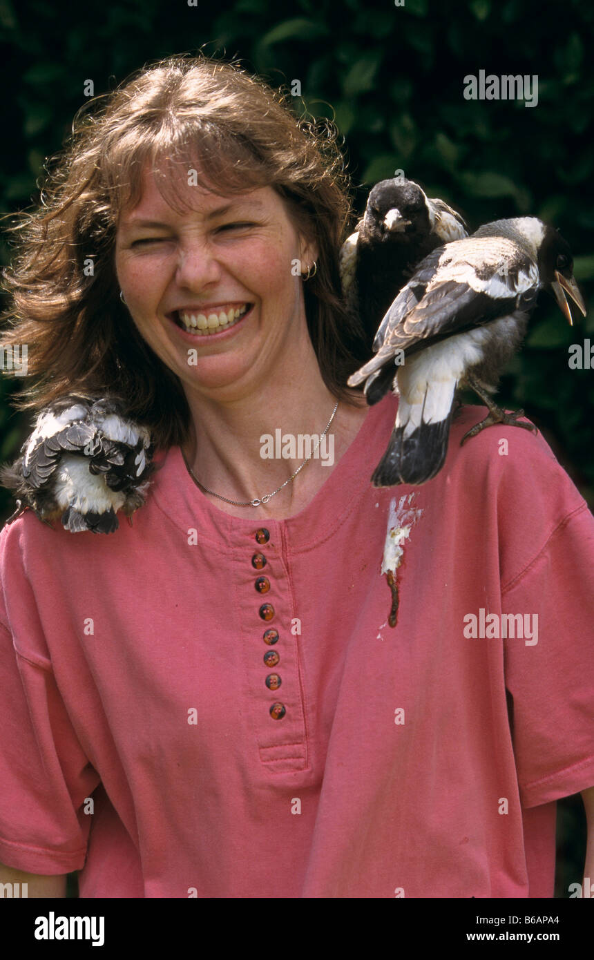 Woman with orphaned magpies, Australia Stock Photo - Alamy