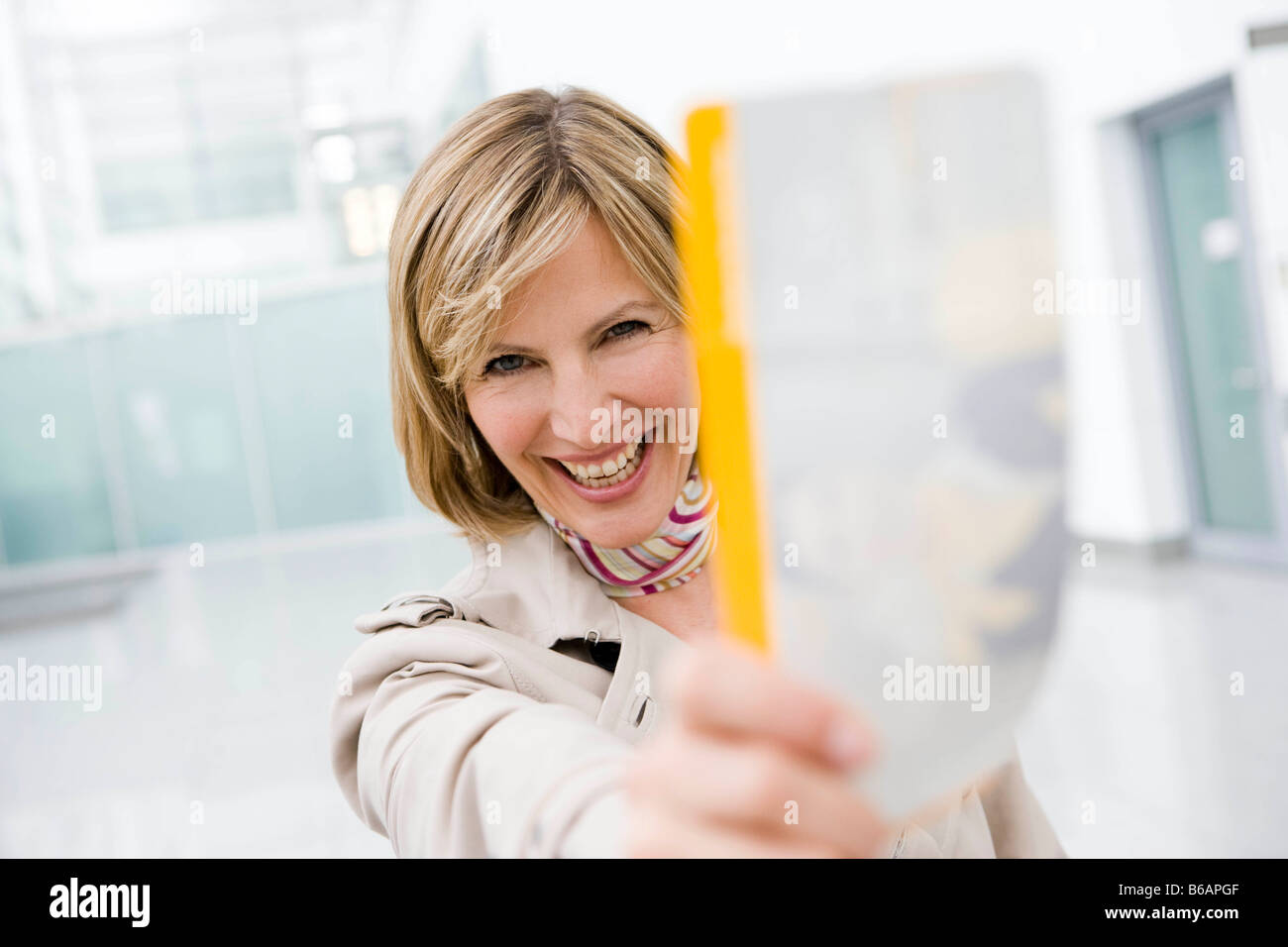 Woman holding ticket smiling Stock Photo - Alamy