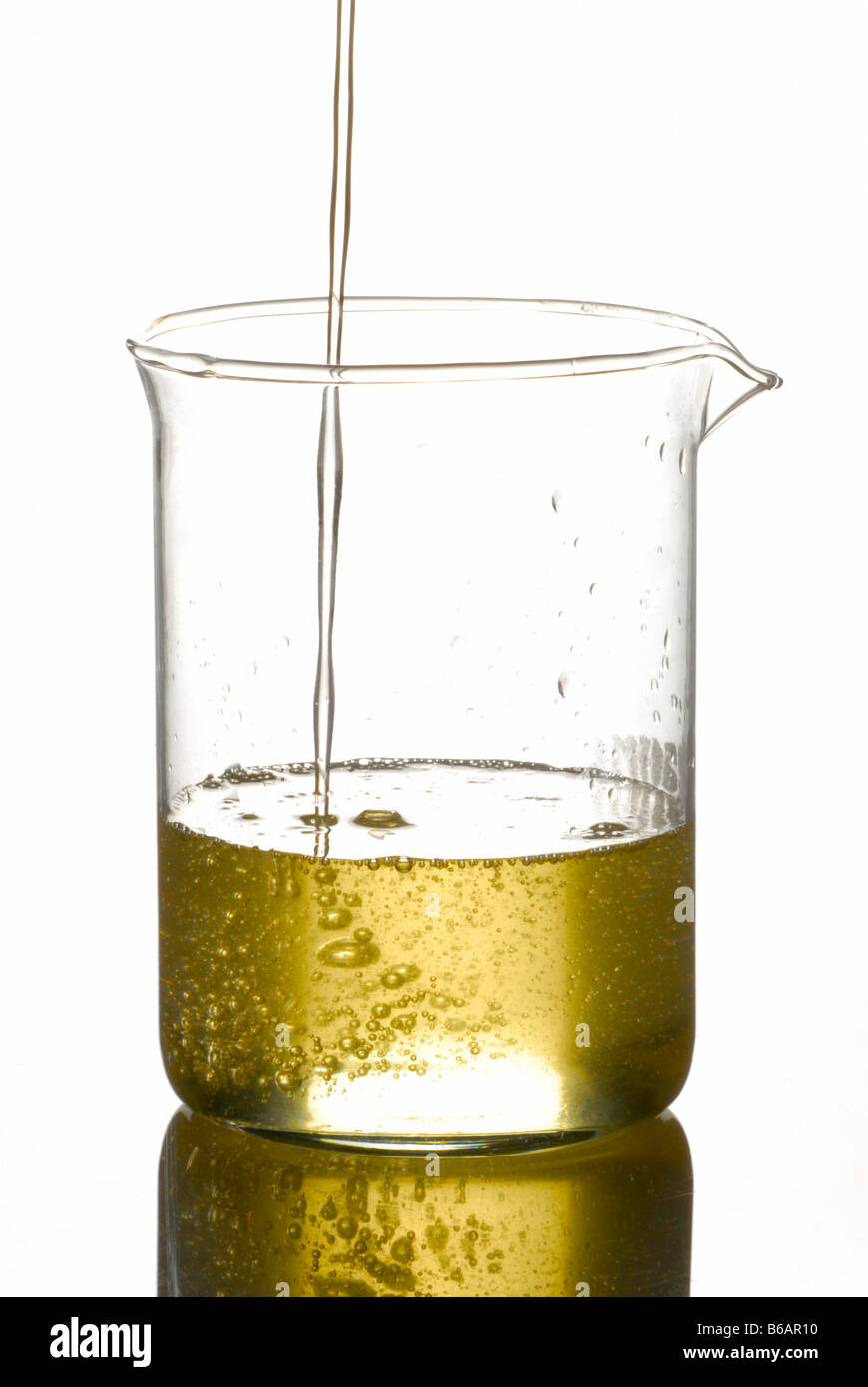 FILLING COCONUT OIL IN A BEAKER Stock Photo - Alamy