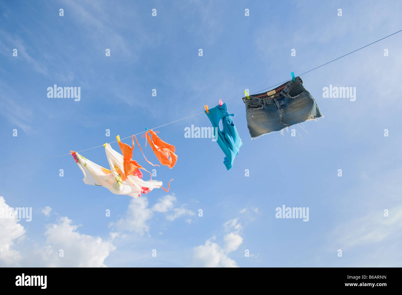Clothes hanging on rope Stock Photo - Alamy