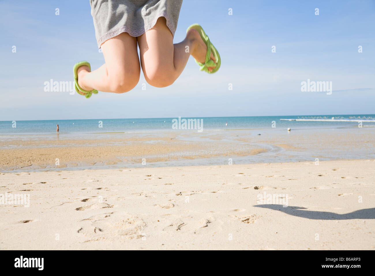Legs of young woman jumping at beach Stock Photo - Alamy