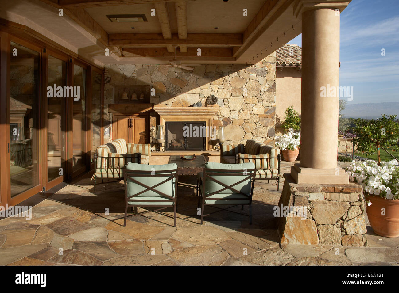 Outdoor living room with fireplace Stock Photo - Alamy