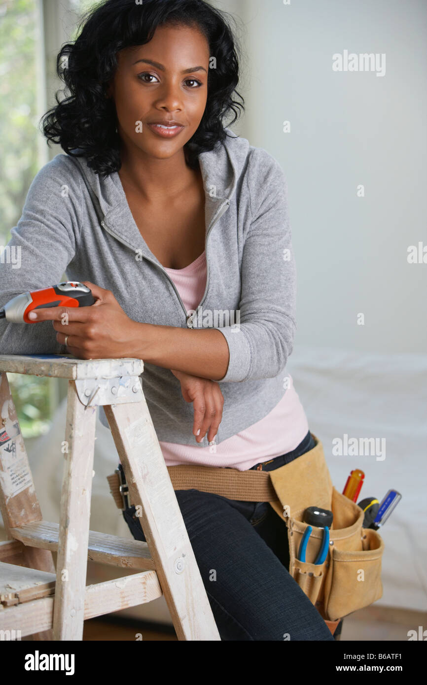 African woman with drill and toolbelt Stock Photo - Alamy