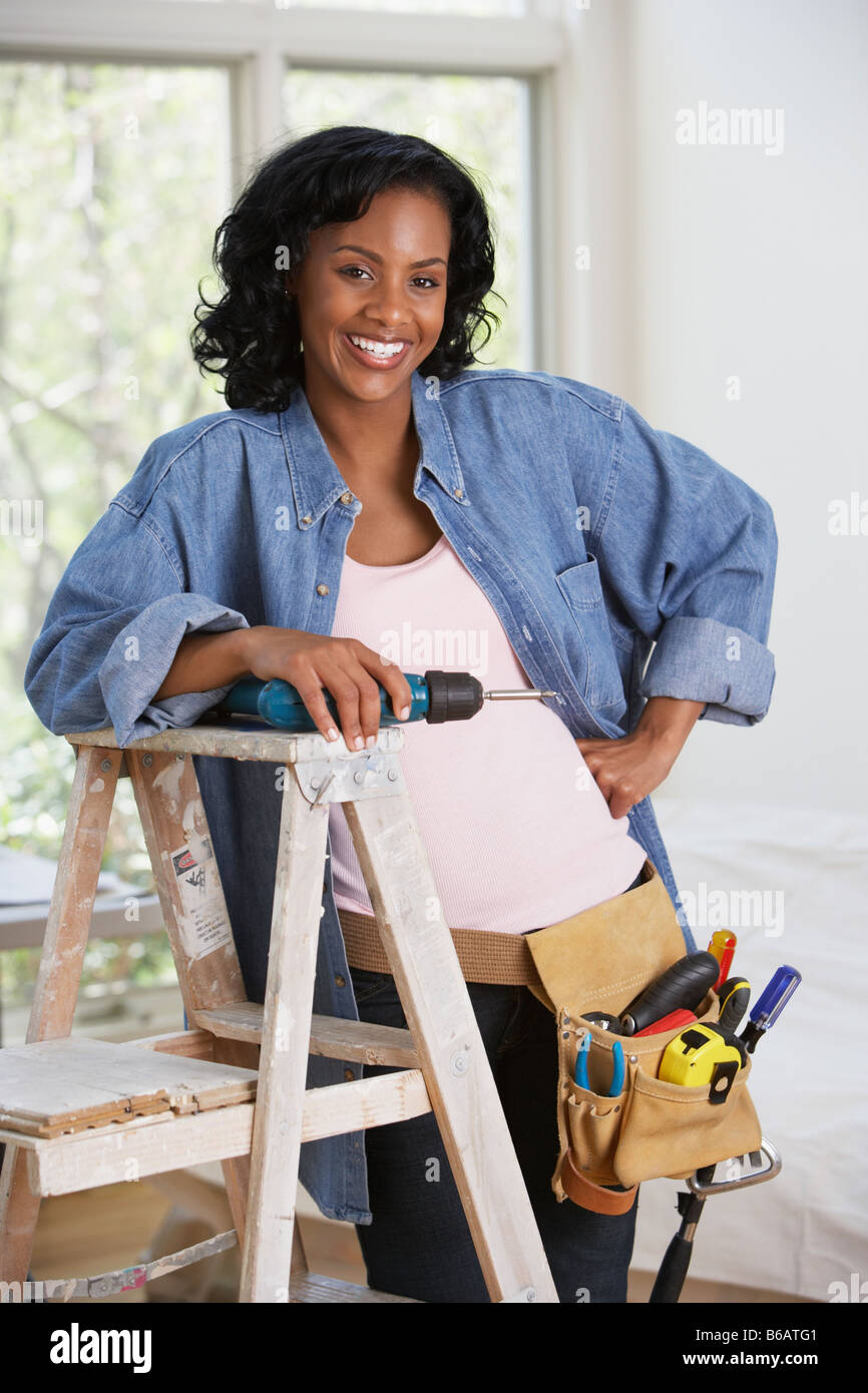 African woman with drill and toolbelt Stock Photo - Alamy