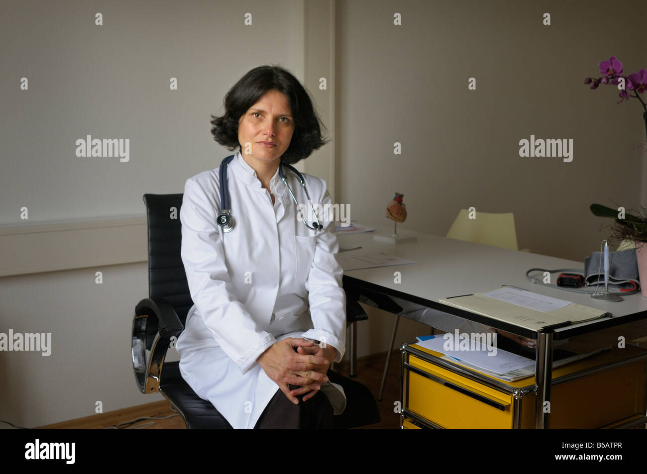 Portrait of female doctor sitting behind her desk Singen Germany Stock ...