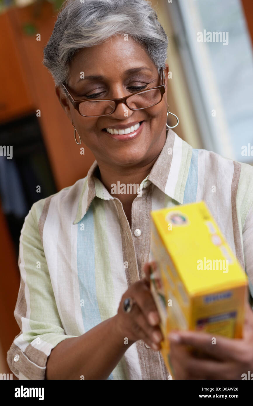 African woman reading food ingredients Stock Photo - Alamy