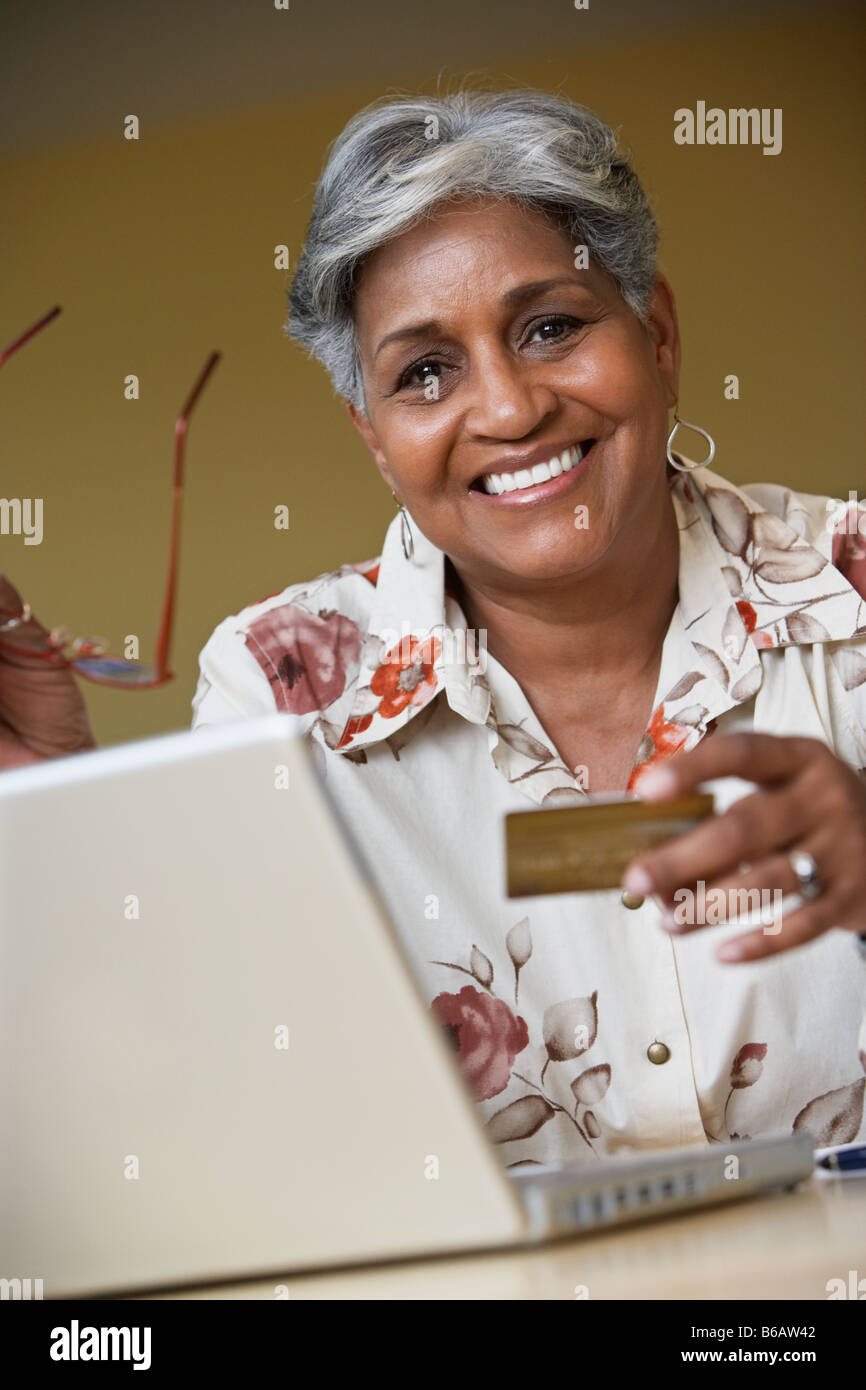 African woman ordering merchandise online with credit card Stock Photo ...