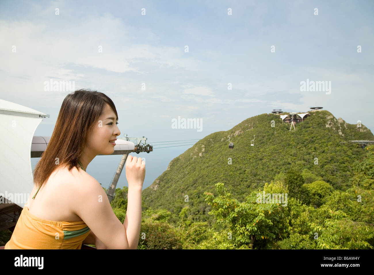 Young woman standing at observatory Stock Photo - Alamy