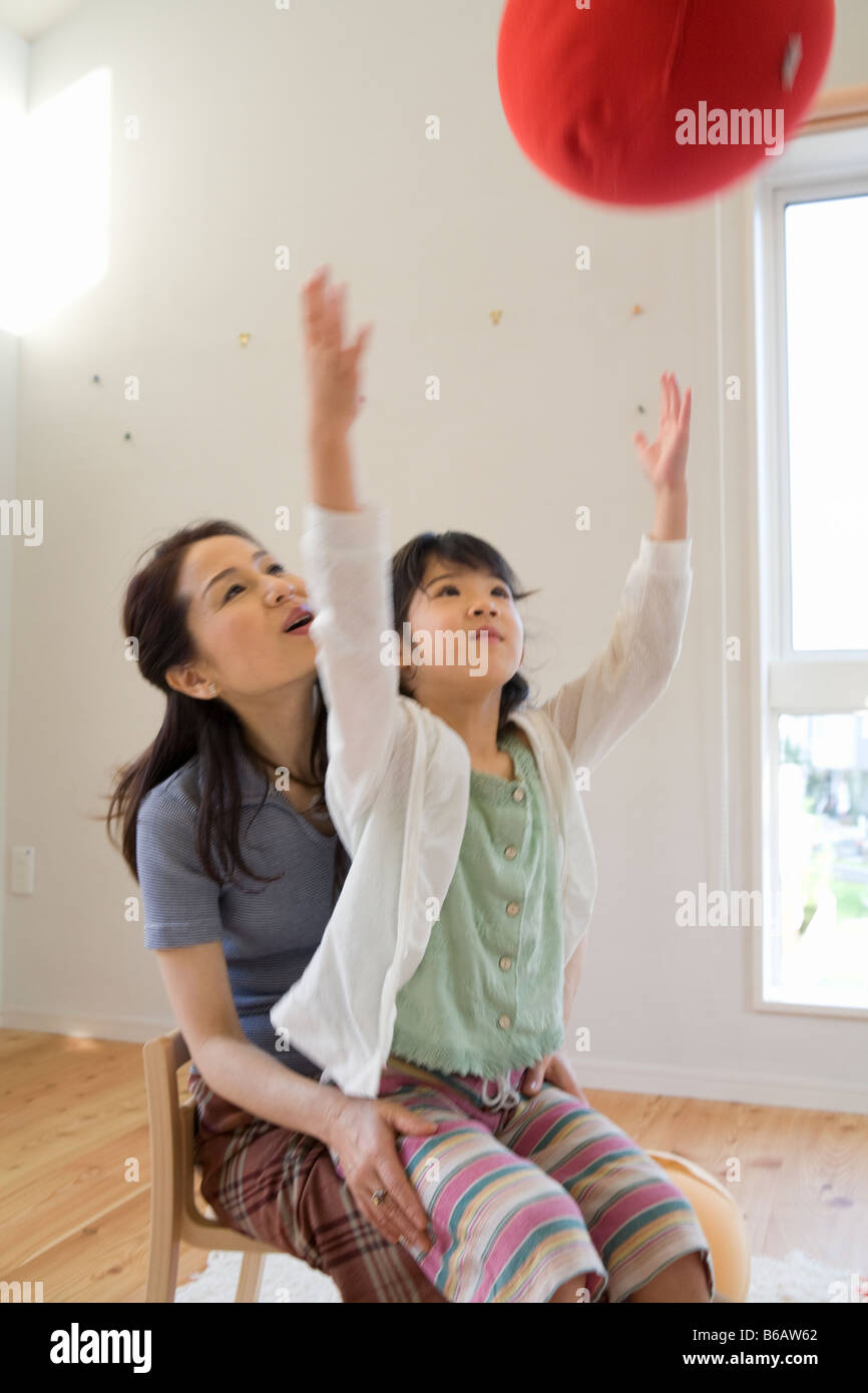 Girl throwing cushion Stock Photo - Alamy