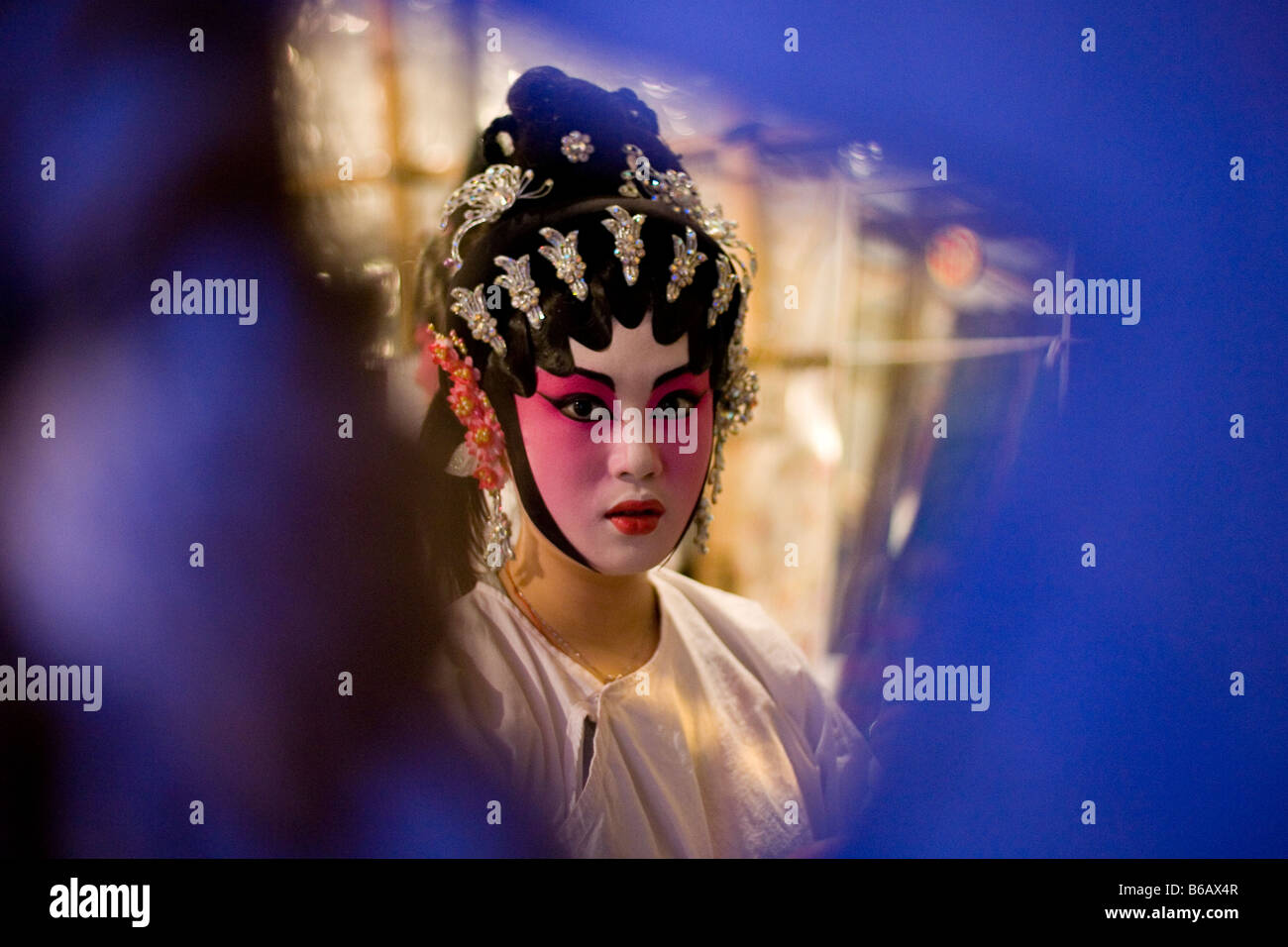 A Performer of Chinese opera waits back stage in Shek O, Hong Kong ...