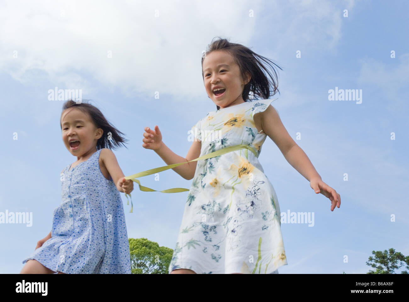 Two girls running Stock Photo - Alamy