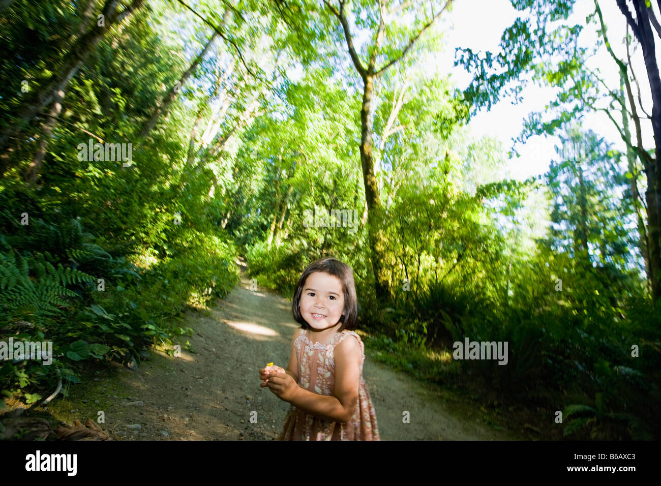 Chinese girl walking along remote wooded path Stock Photo - Alamy