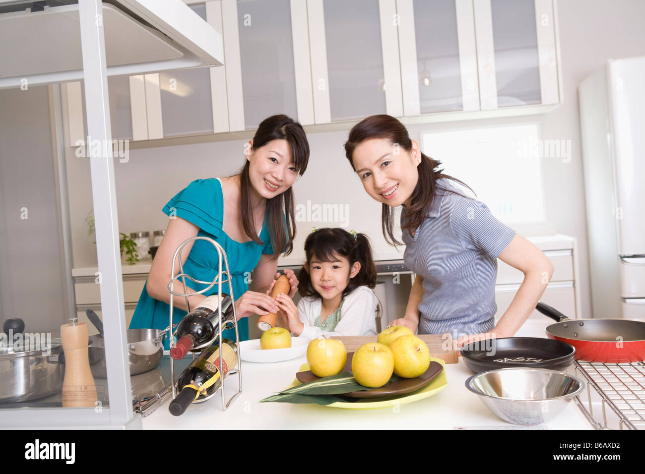 Family cooking in kitchen Stock Photo - Alamy
