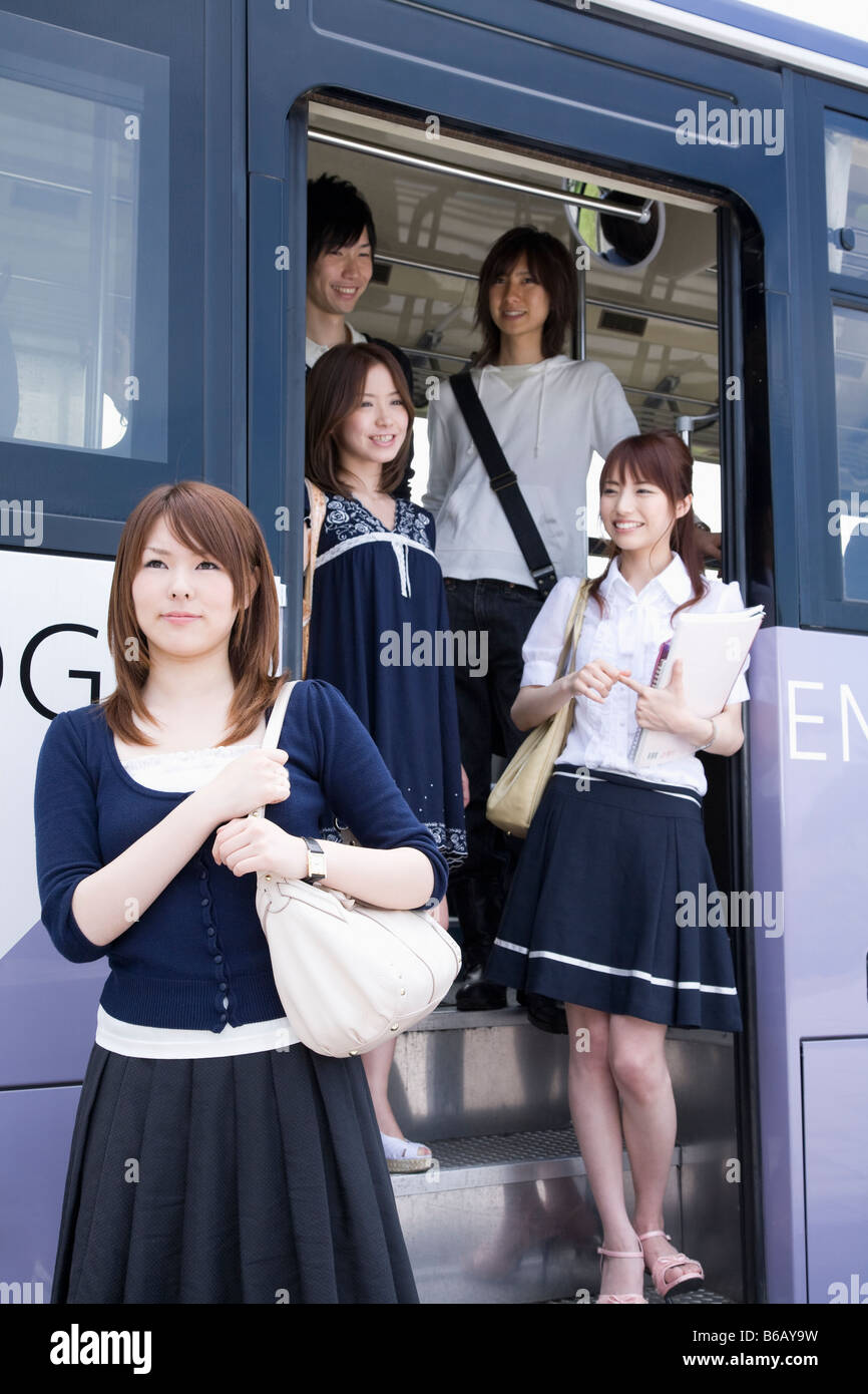 College students getting off the bus Stock Photo - Alamy