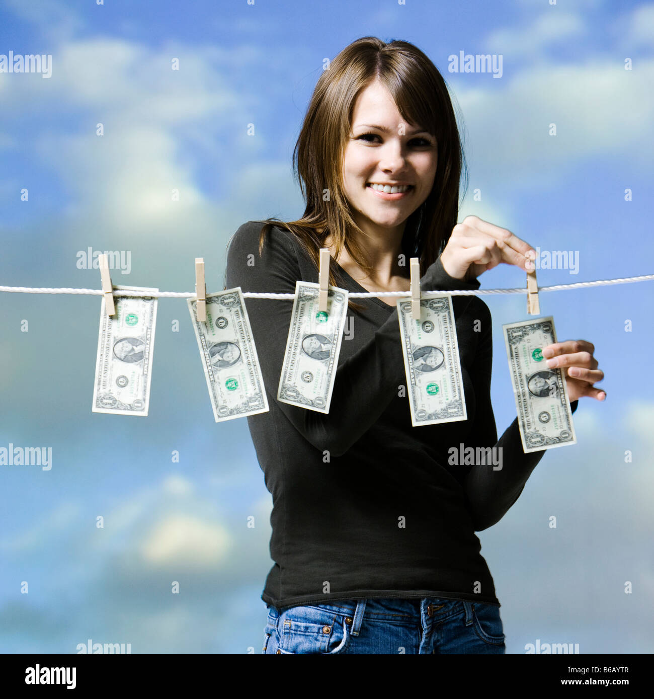woman hanging money out to dry Stock Photo - Alamy