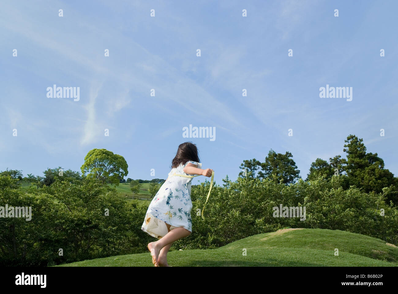 Girl running on grass field Stock Photo - Alamy