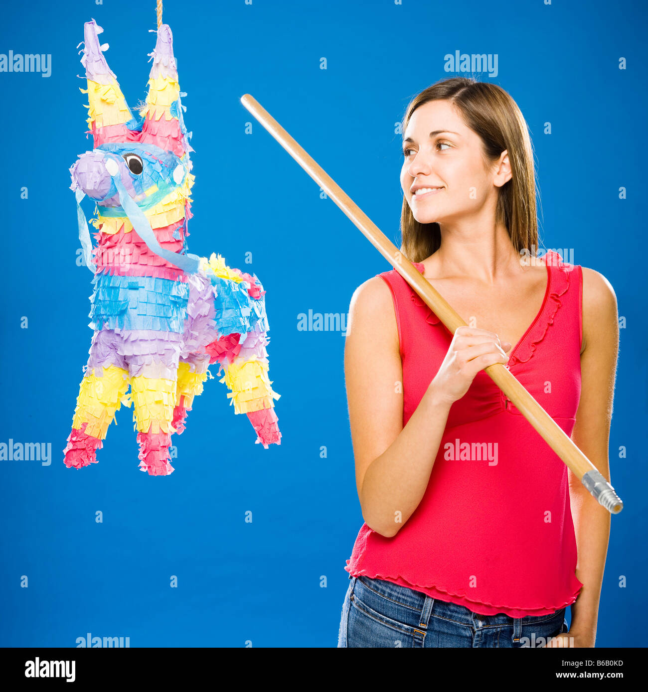 woman hitting a pinata Stock Photo - Alamy