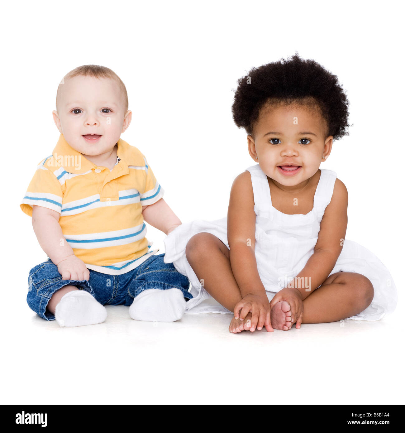 Two babies sitting Stock Photo - Alamy
