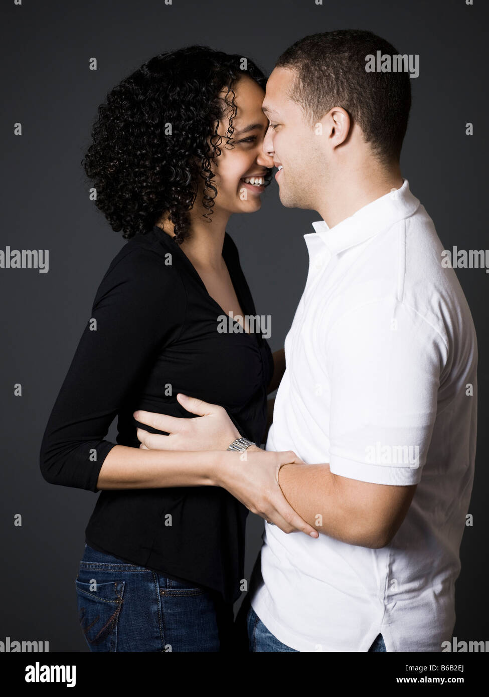 Studio mixed race couple kissing hi-res stock photography and images ...