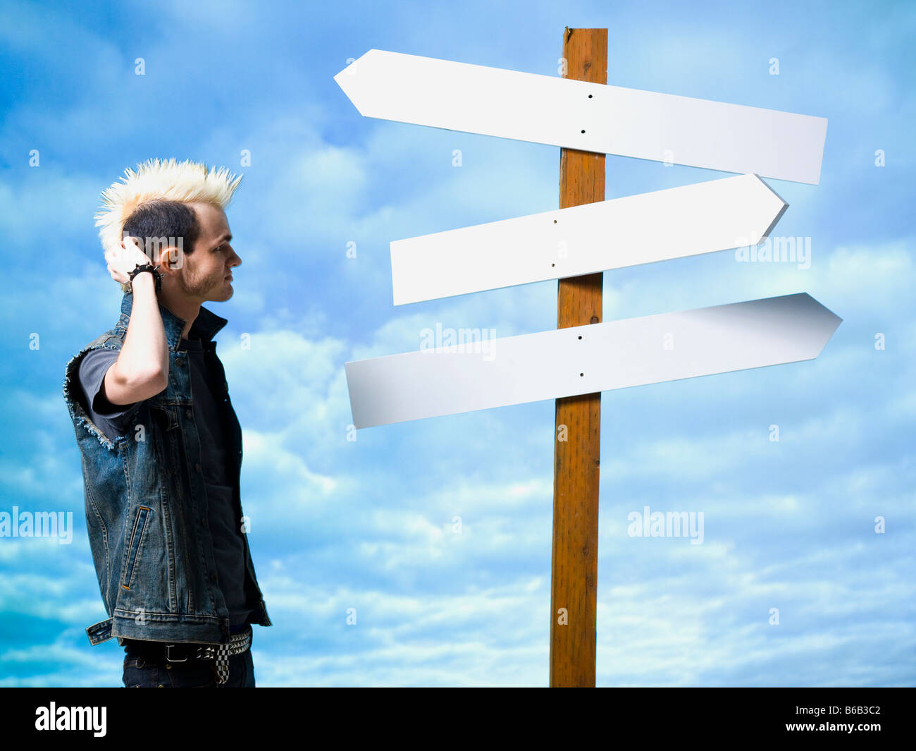 man looking at road sign Stock Photo - Alamy