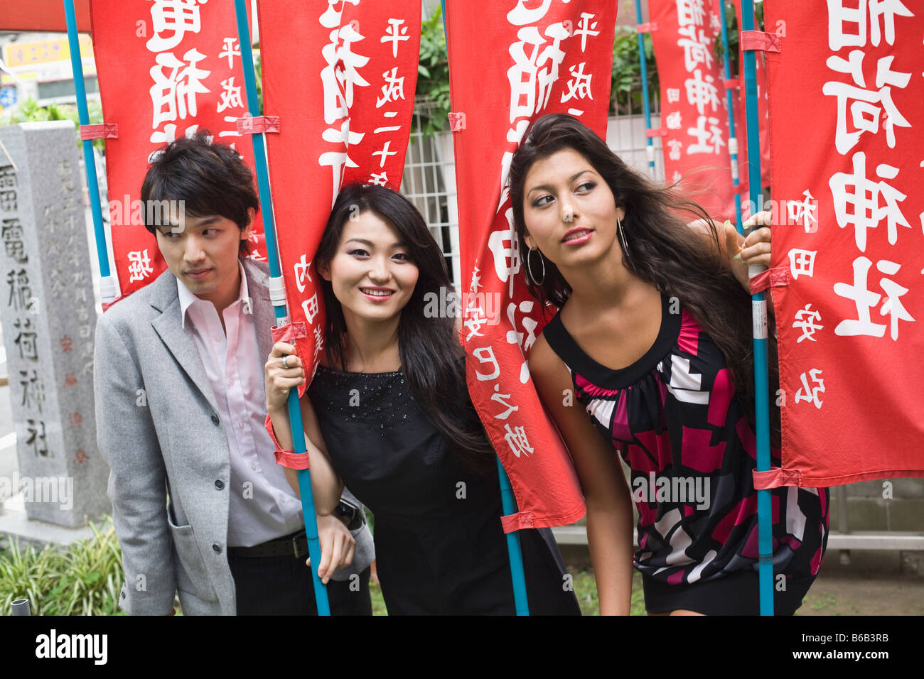 Japanese friends posing with flags Stock Photo - Alamy