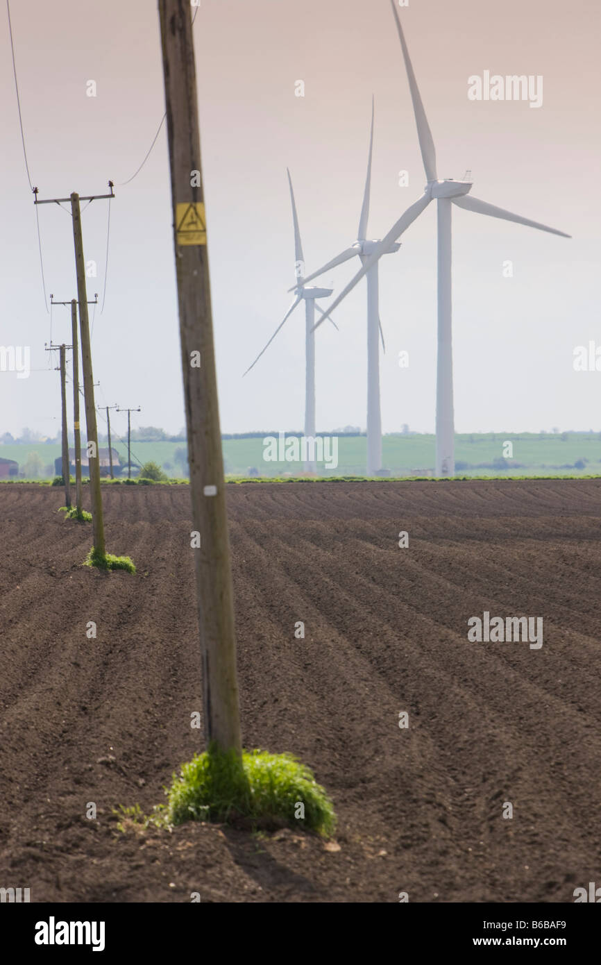 Wind turbines with leaning telegraph poles and powerlines Stock Photo ...