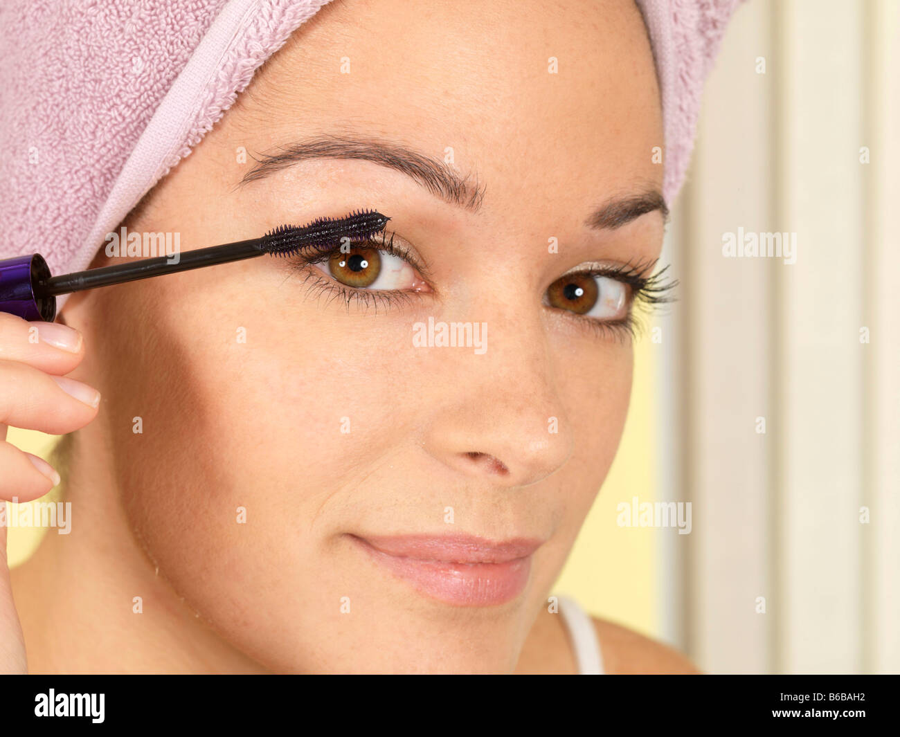 Young Woman Applying Mascara Model Released Stock Photo - Alamy