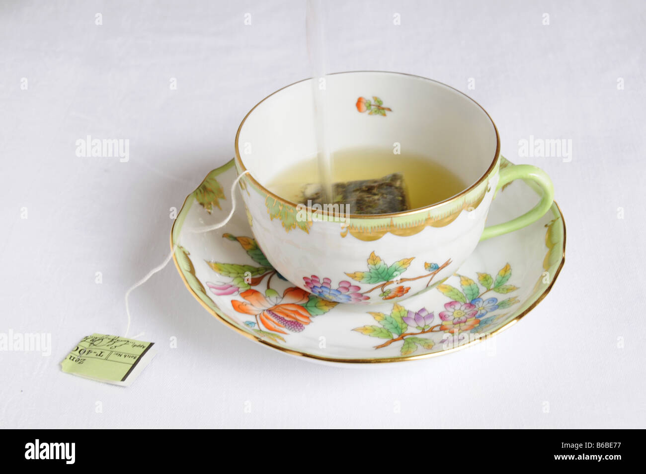 Pouring water into tea cup Stock Photo - Alamy