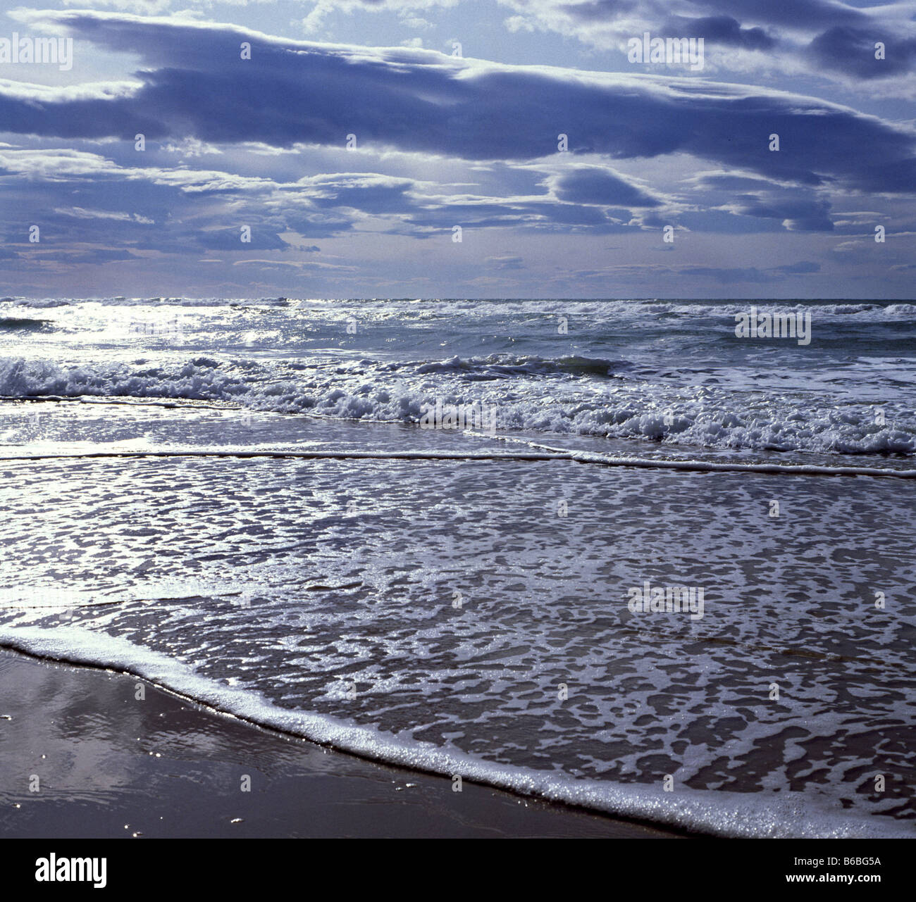 Waves on beach Stock Photo - Alamy